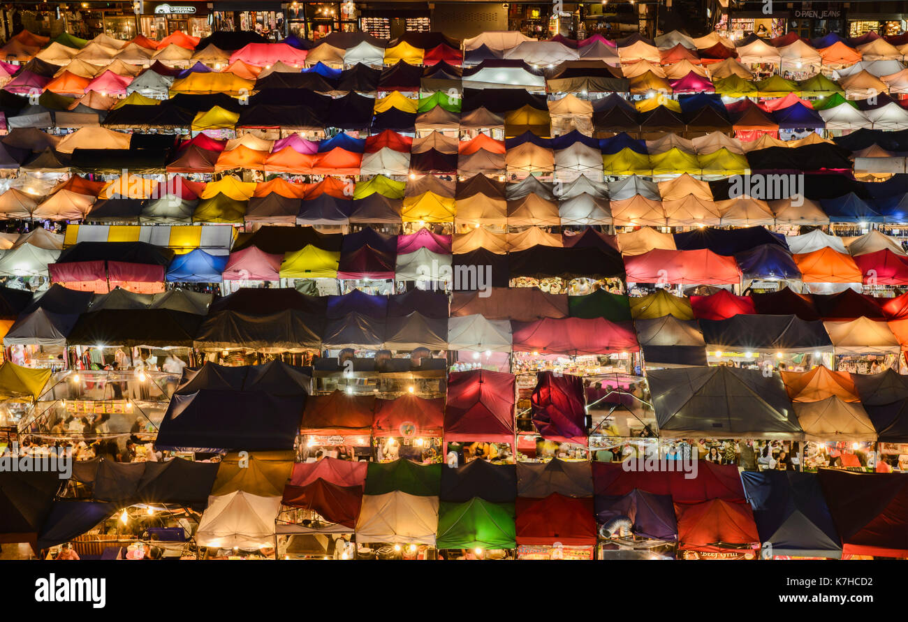 The colorful Ratchada Rot Fai Train Market at sunset, Bangkok, Thailand ...