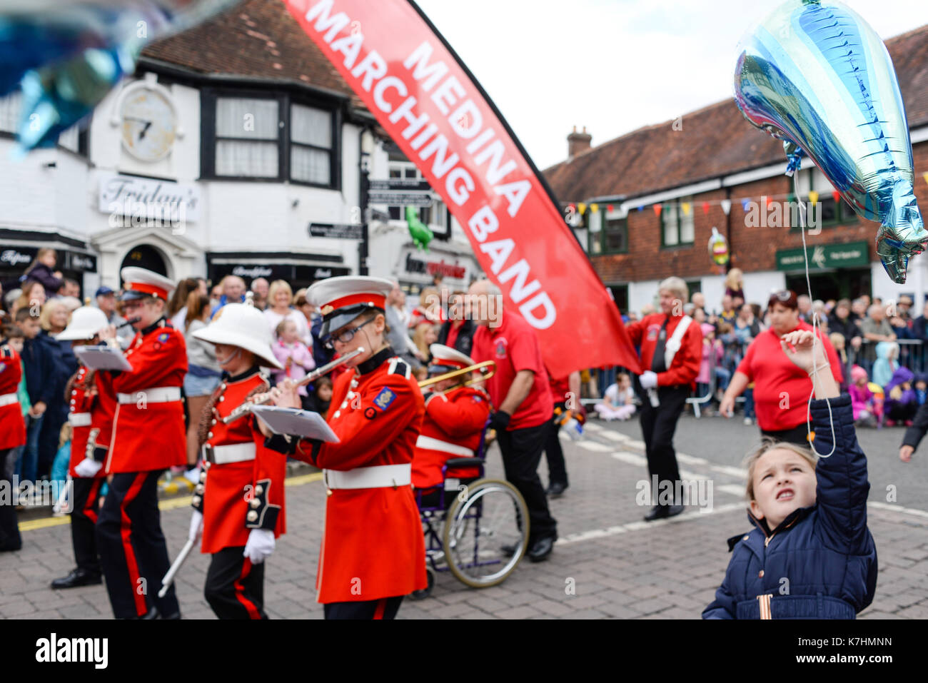 Marching band wearing red tunics in a carnival procession Stock Photo ...
