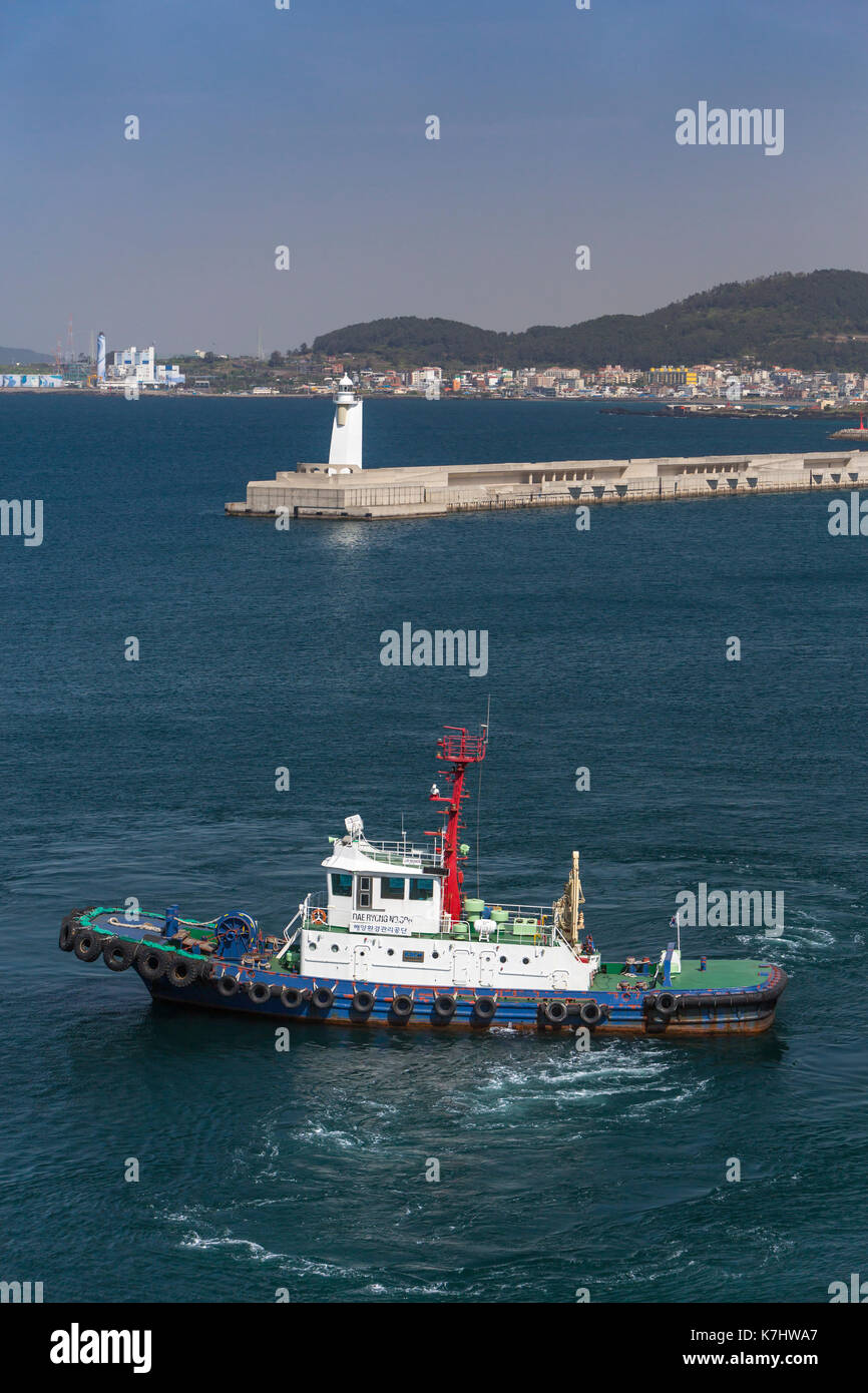 A tugboat in the harbor at the port of Jeju, Jeju Island, South Korea ...
