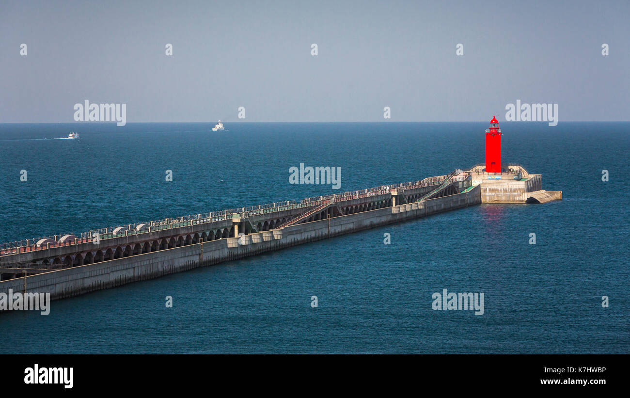 A lighthouse on the breakwater at the port of Jeju, Jeju Island, South ...