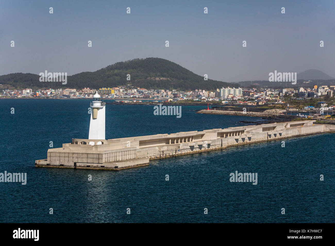 A lighthouse on the breakwater at the port of Jeju, Jeju Island, South ...