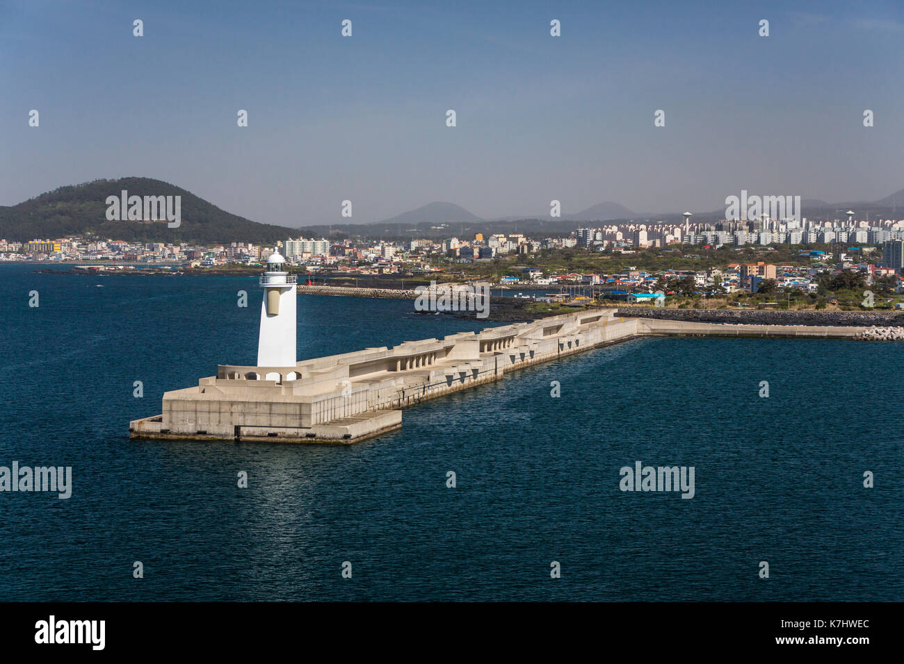 A lighthouse on the breakwater at the port of Jeju, Jeju Island, South ...