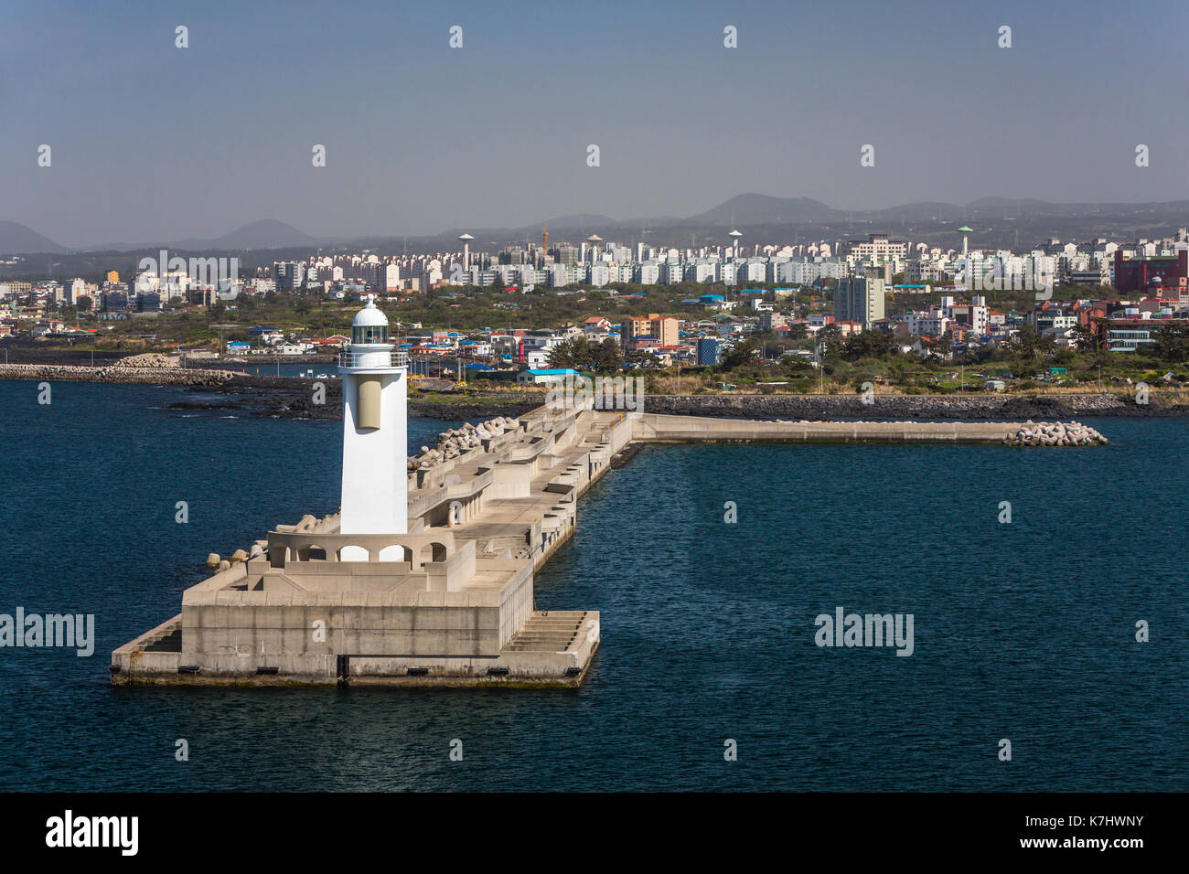 A lighthouse on the breakwater at the port of Jeju, Jeju Island, South ...