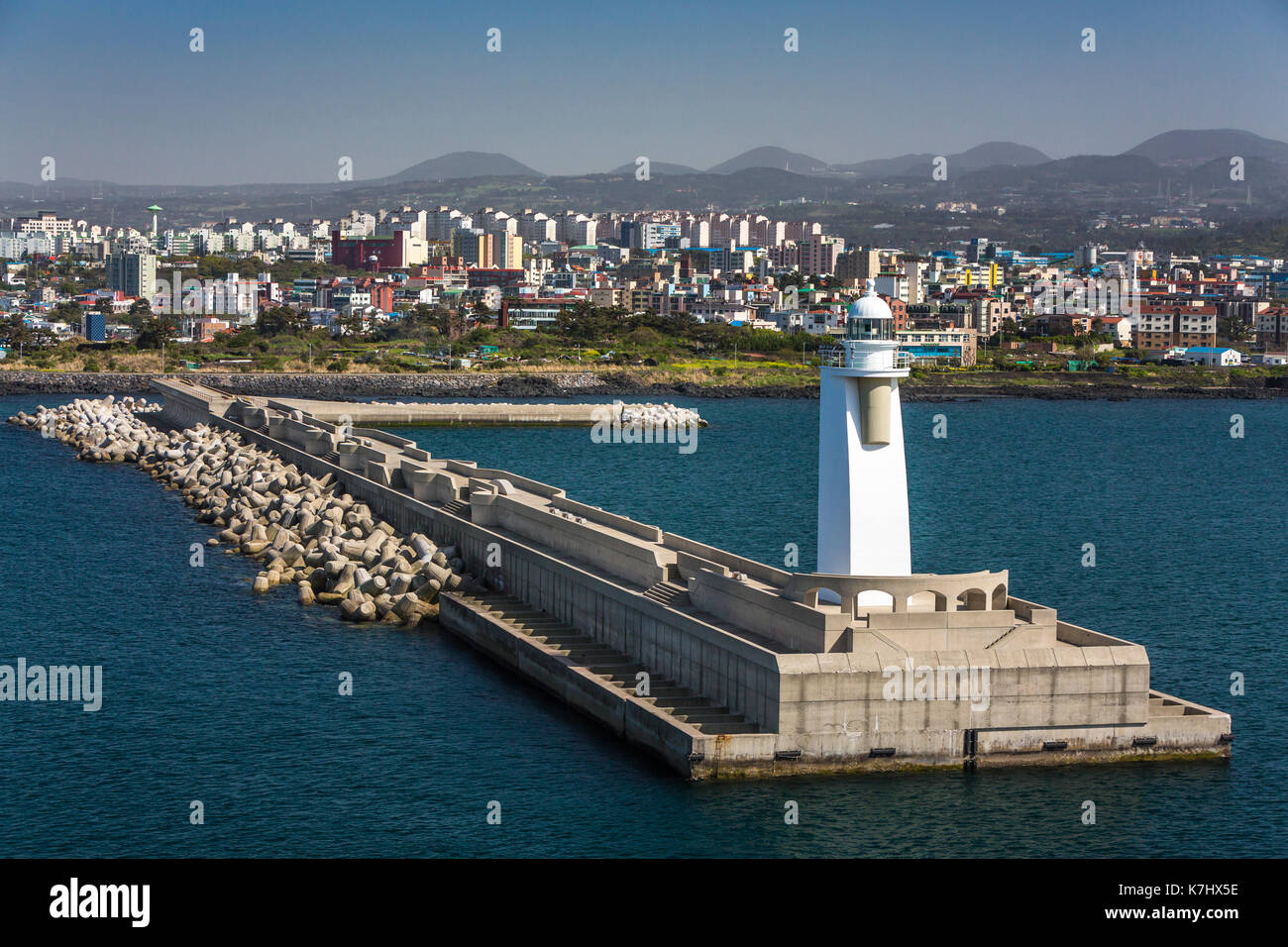 A lighthouse on the breakwater at the port of Jeju, Jeju Island, South ...