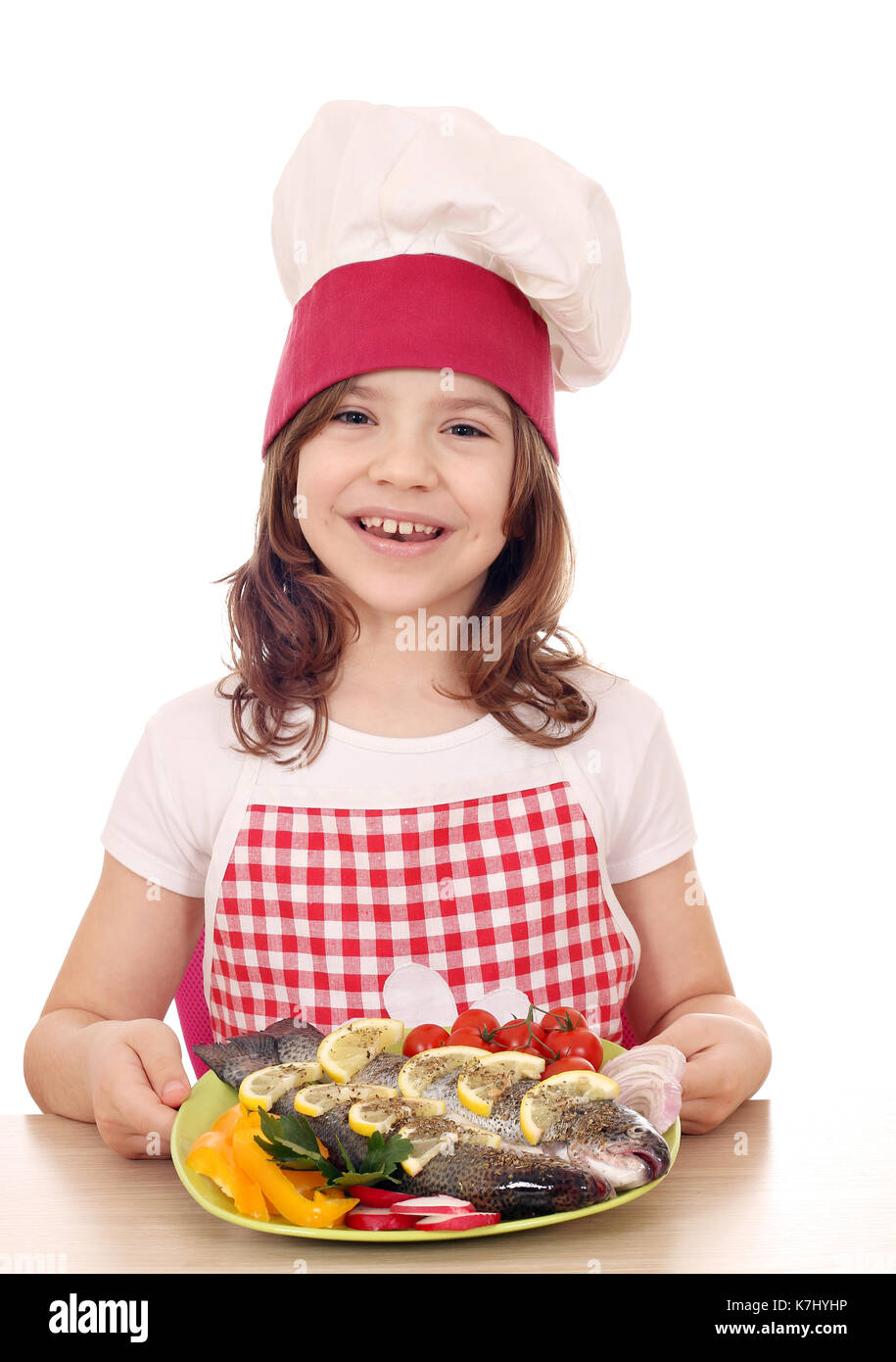 happy little girl cook with prepared fish on plate Stock Photo - Alamy