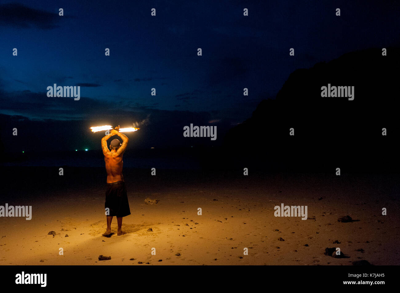 Fire performer on a beach Stock Photo - Alamy