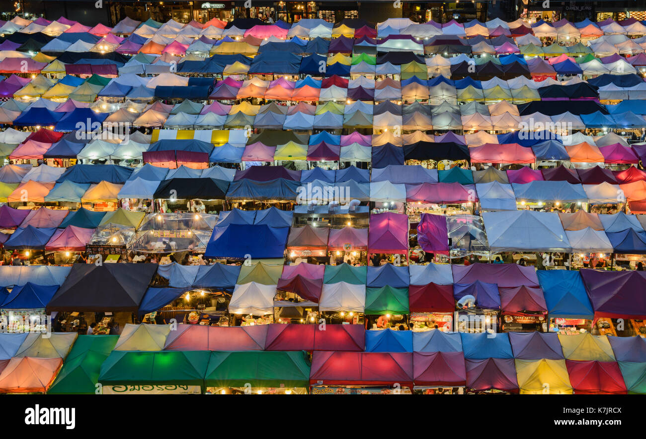 The colorful Ratchada Rot Fai Train Market at sunset, Bangkok, Thailand ...