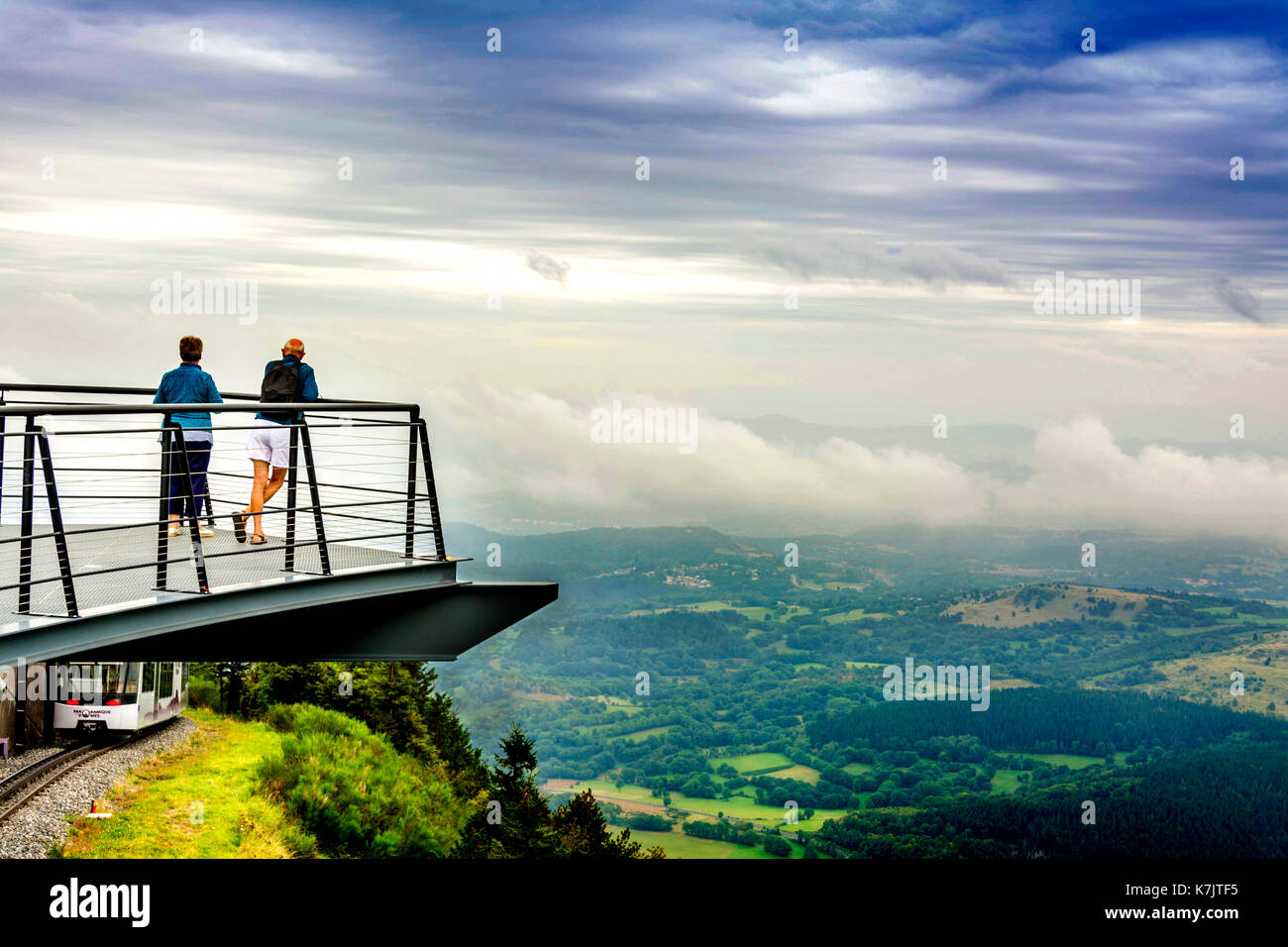 Walkers on a viewing platform facing the Limagne plain from Volcano of ...