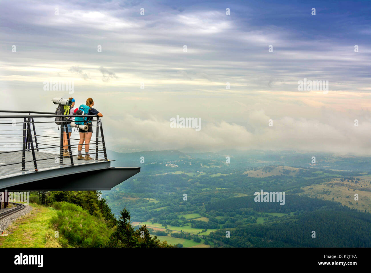Walkers on a viewing platform facing the Limagne plain from Volcano of ...