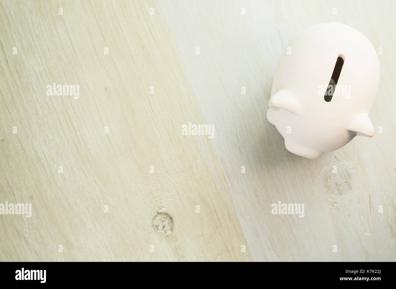 terracotta piggy bank on a bright painted wood background - top view ...