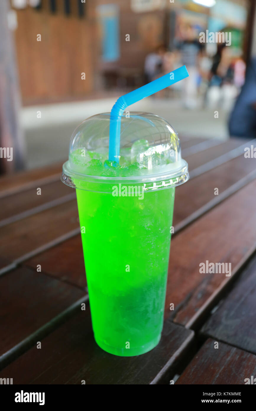 Green soda soft drink in glass on the food table Stock Photo - Alamy