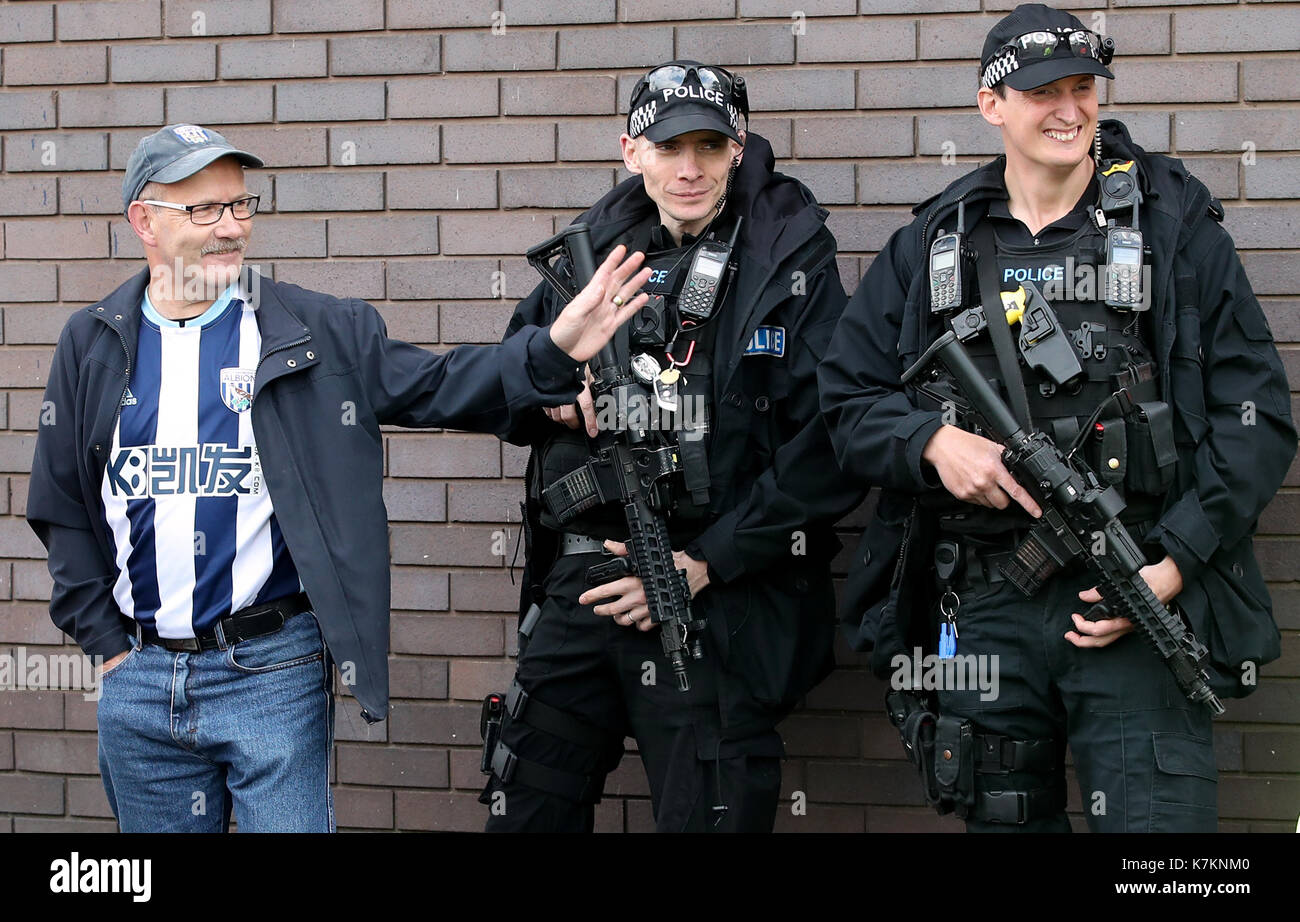 Armed police next to a West Bromwich Albion fan before the Premier ...