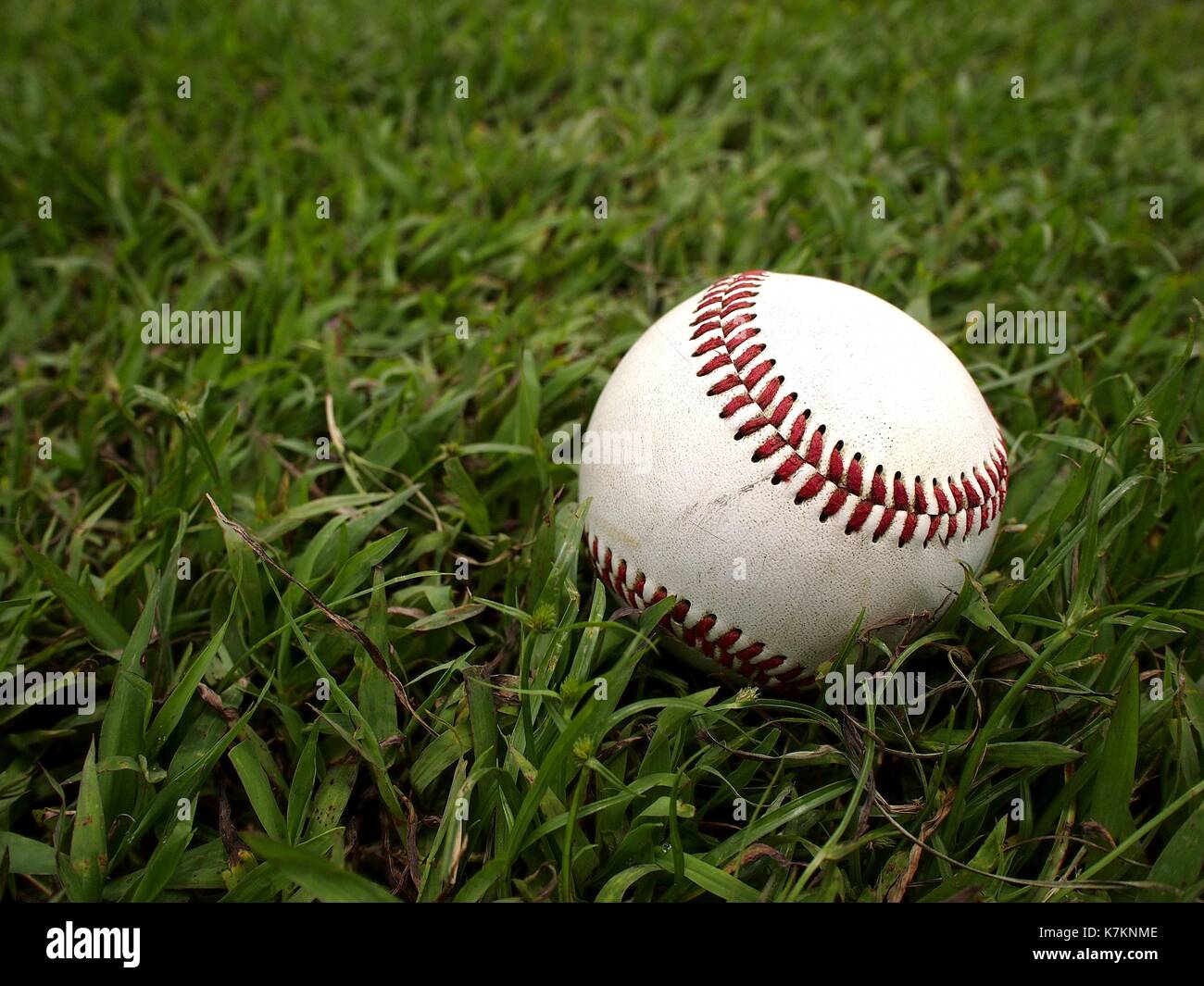 Photo of a baseball on a field of grass Stock Photo - Alamy