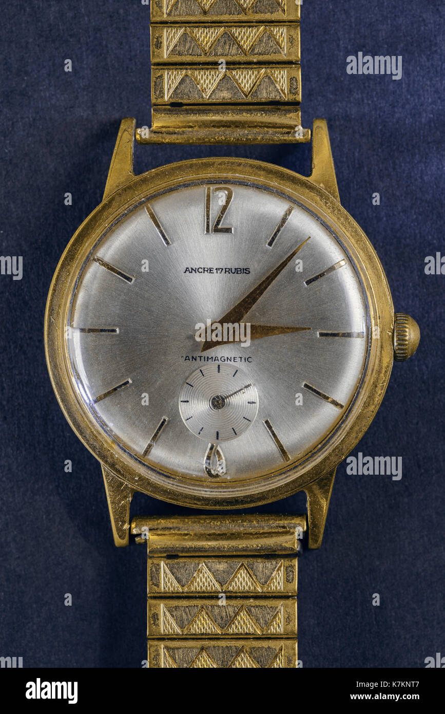 Close up old golden watch isolated on blue background Stock Photo - Alamy