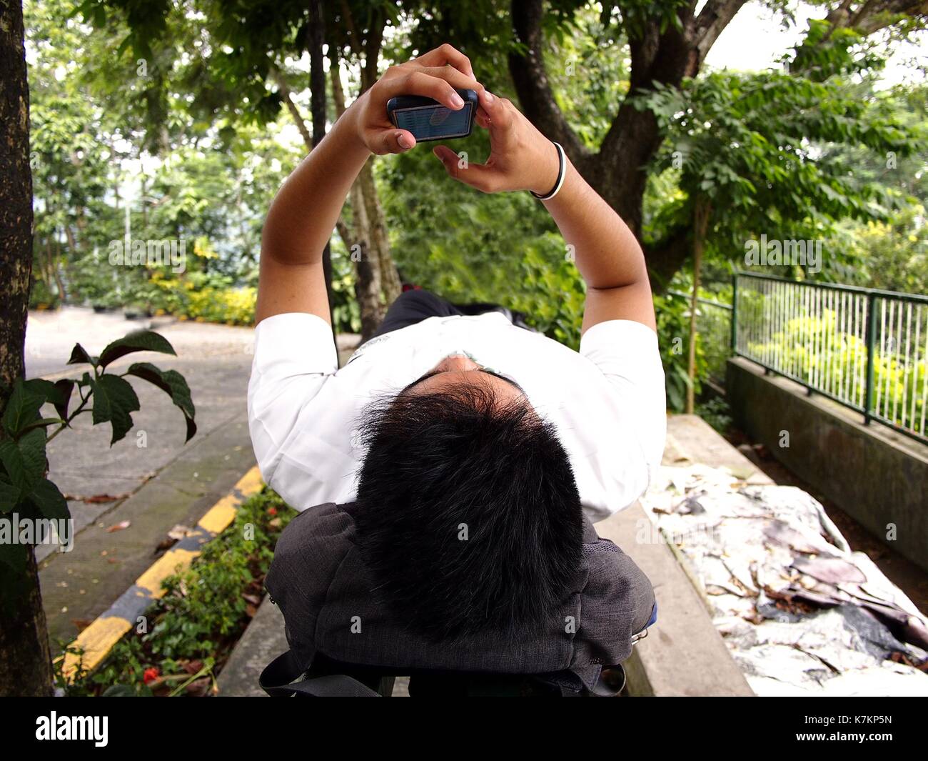 Boy lying down on bench hi-res stock photography and images - Alamy