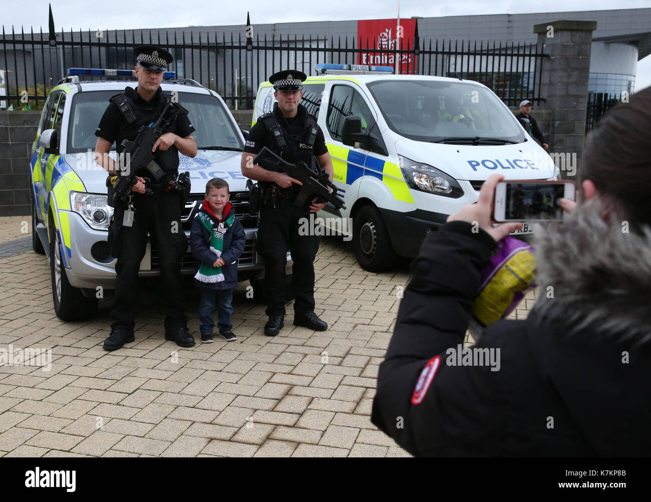 Armed police pose with a young fan outside Celtic Park prior to the ...