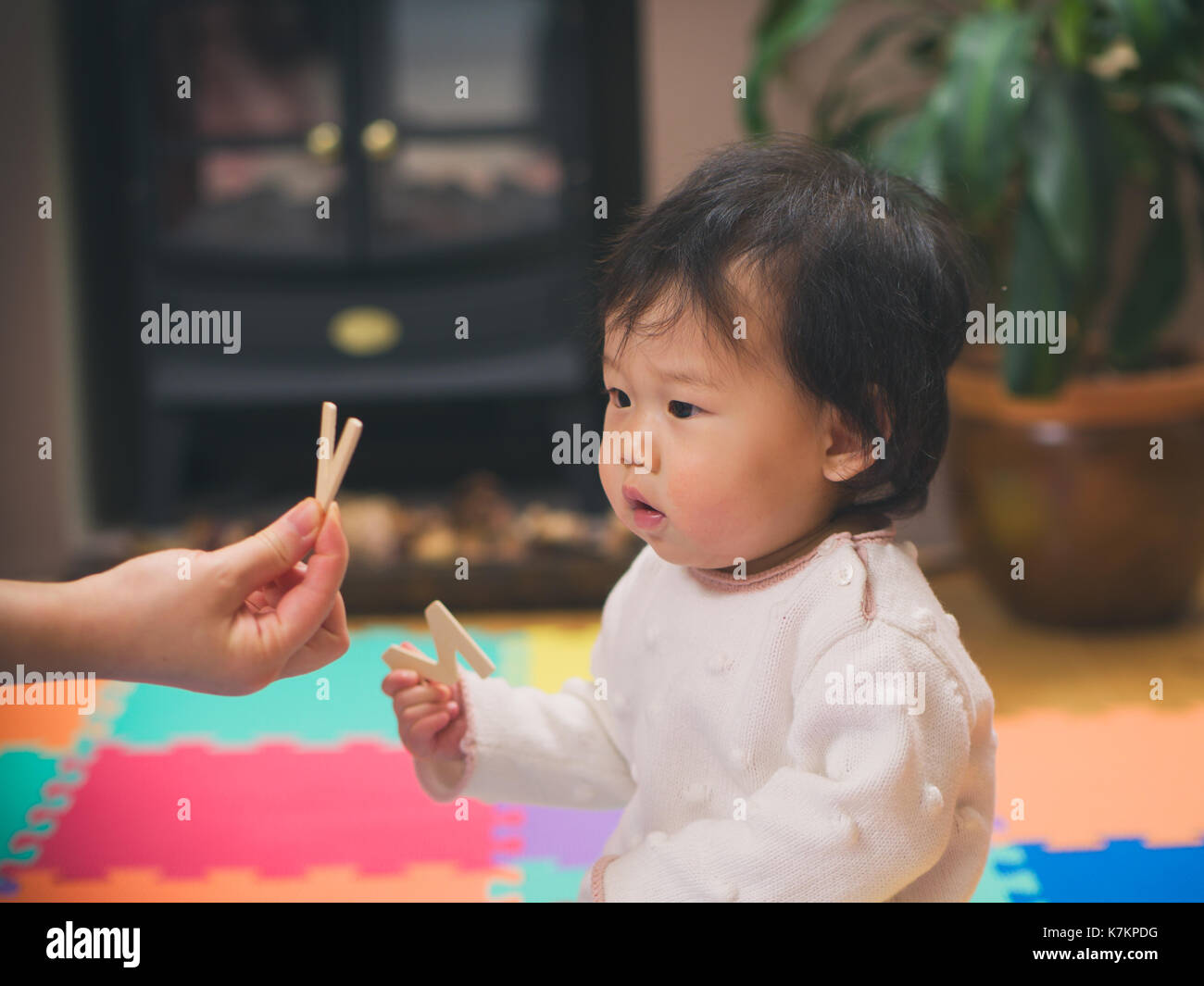 Asian baby girl learning English letters Stock Photo - Alamy