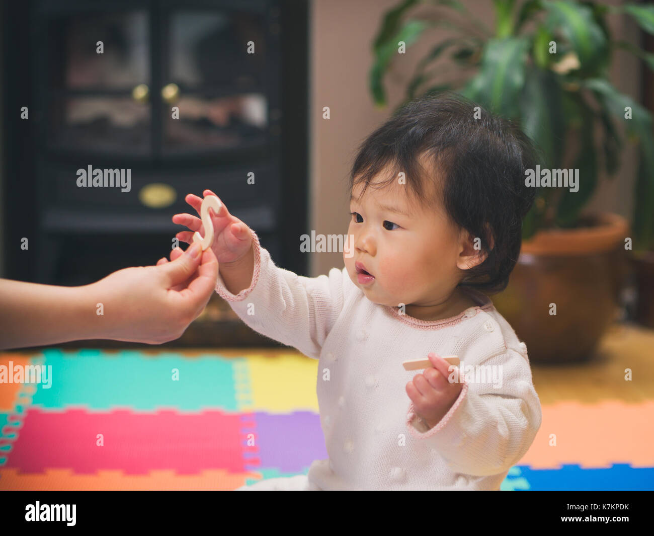 Asian baby girl learning English letters Stock Photo - Alamy