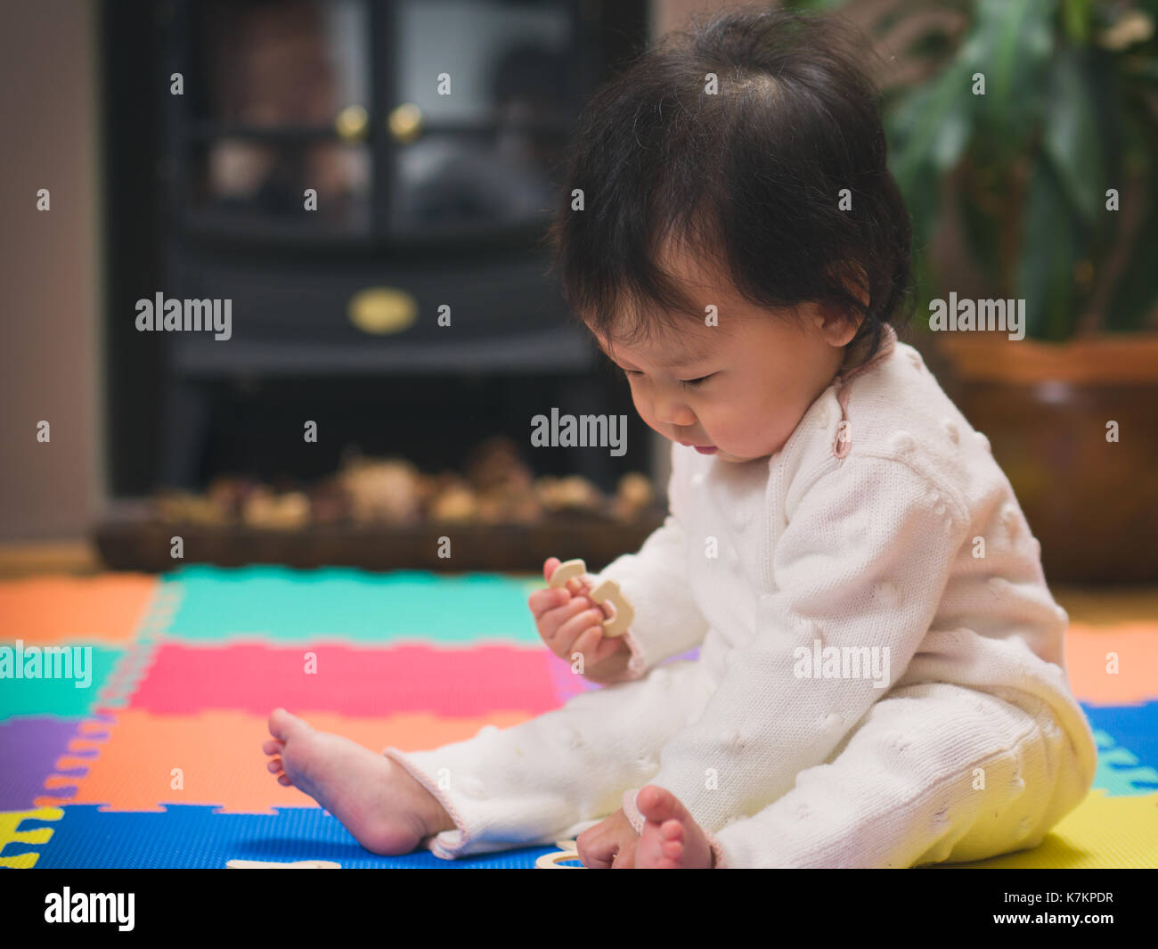 Asian baby girl learning English letters Stock Photo - Alamy