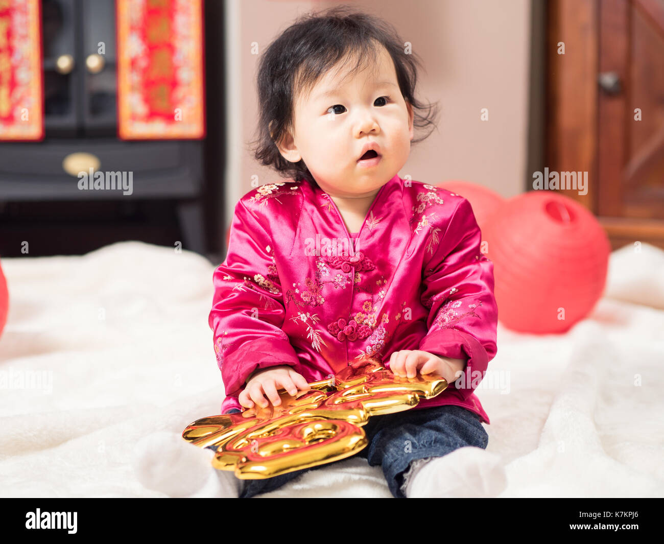 happy baby girl hold "FU" Chinese words for Chinese new year "FU" means ...