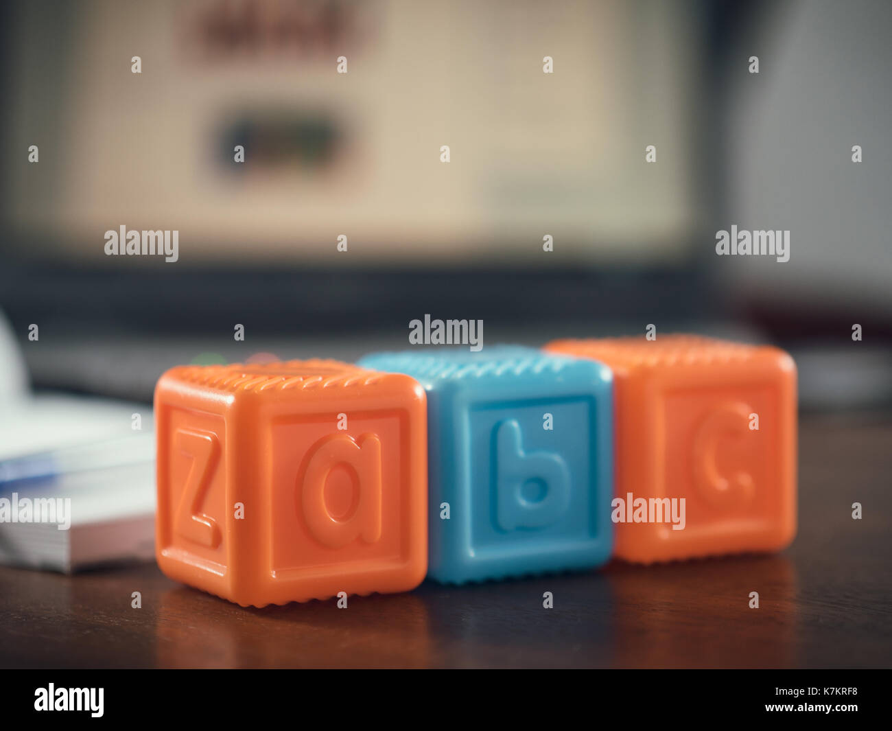 alphabet cubes on office table against blur laptop background Stock ...