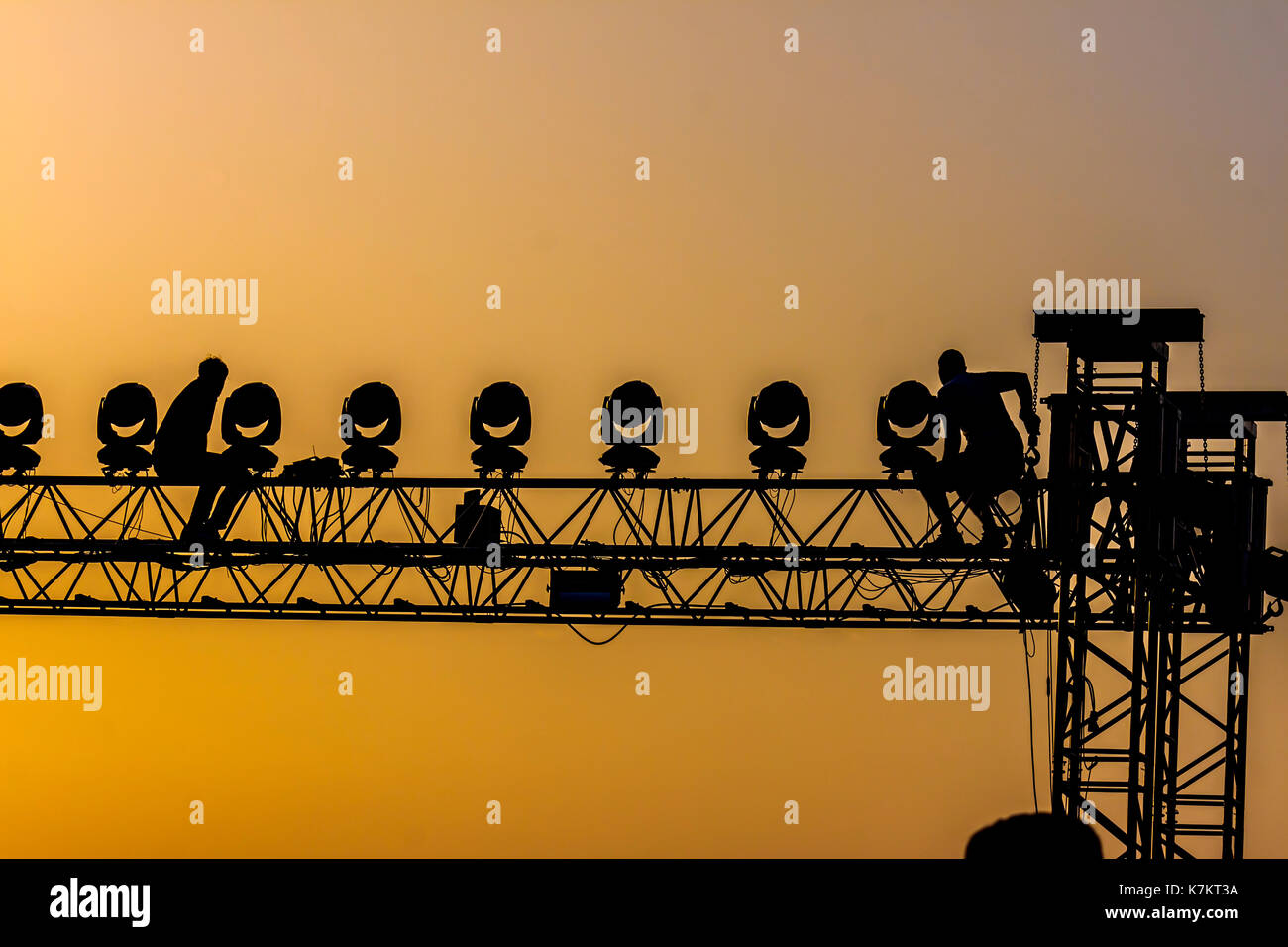 Workers on concert structure in the sunset backlight Stock Photo - Alamy