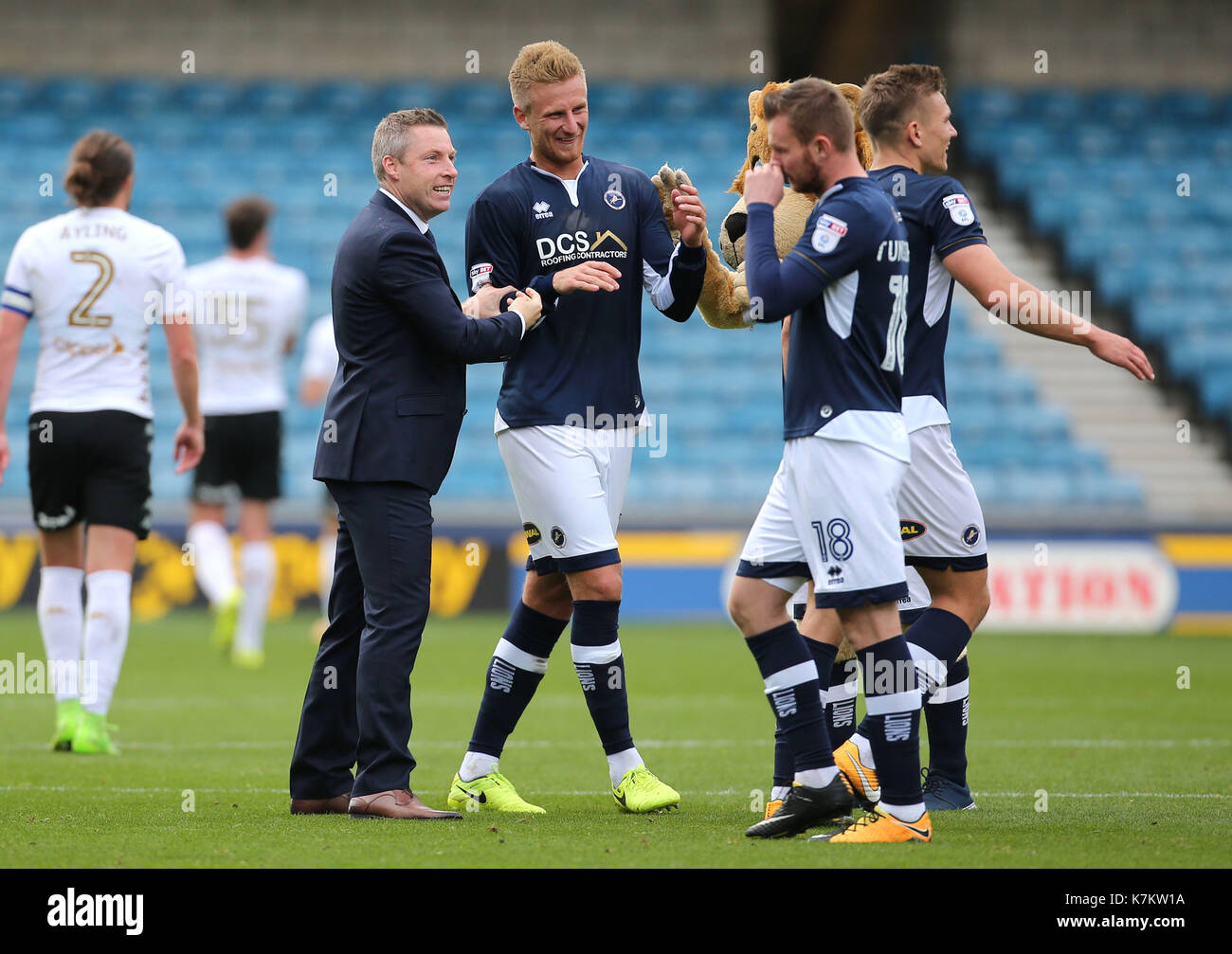 Millwall manager Neil Harris celebrates with Byron Webster and Ryan ...
