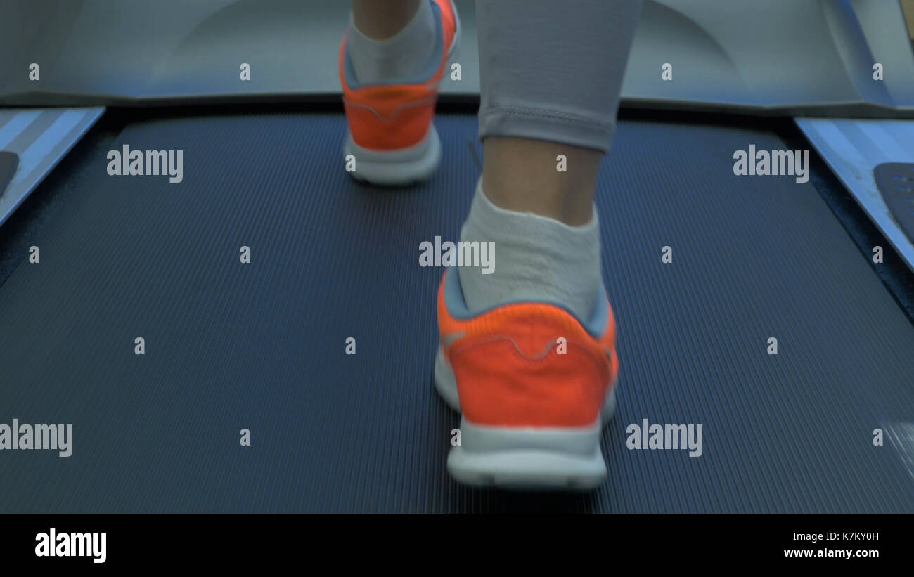 Woman's muscular legs on treadmill. woman's muscular legs on treadmill ...