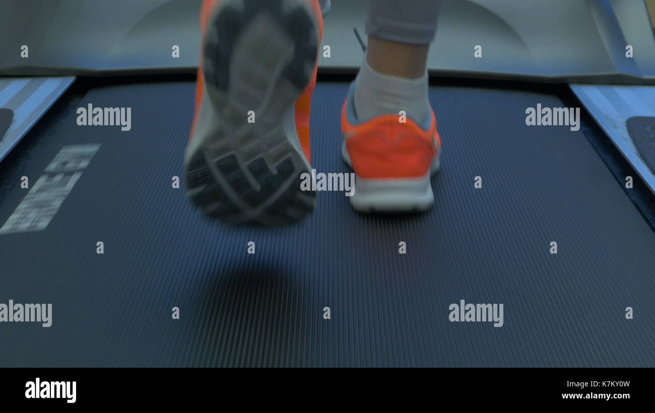 Woman's muscular legs on treadmill. woman's muscular legs on treadmill ...