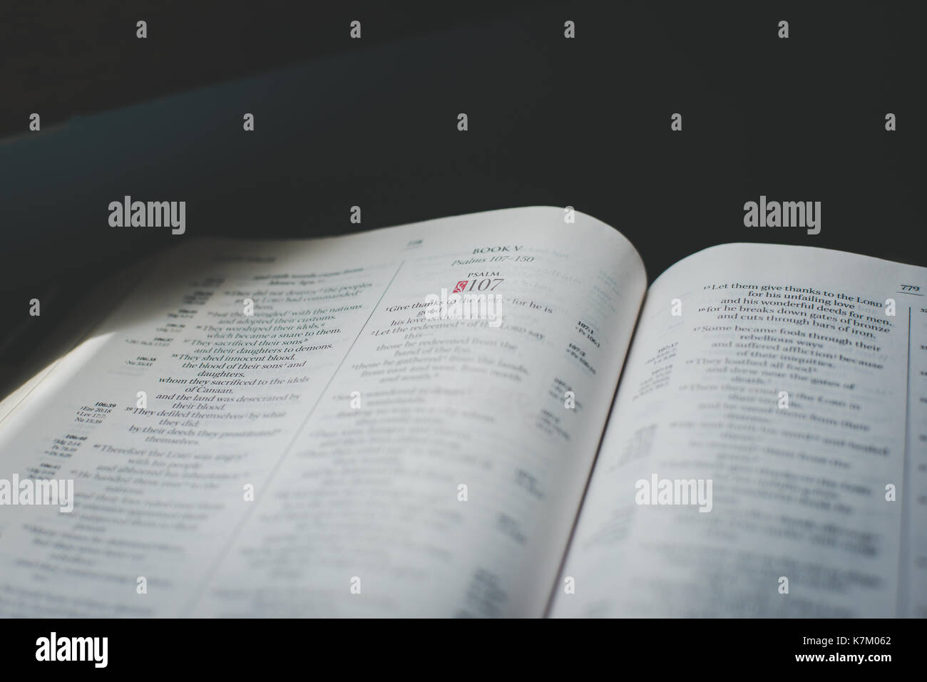 Bible laying open against a dark background Stock Photo - Alamy