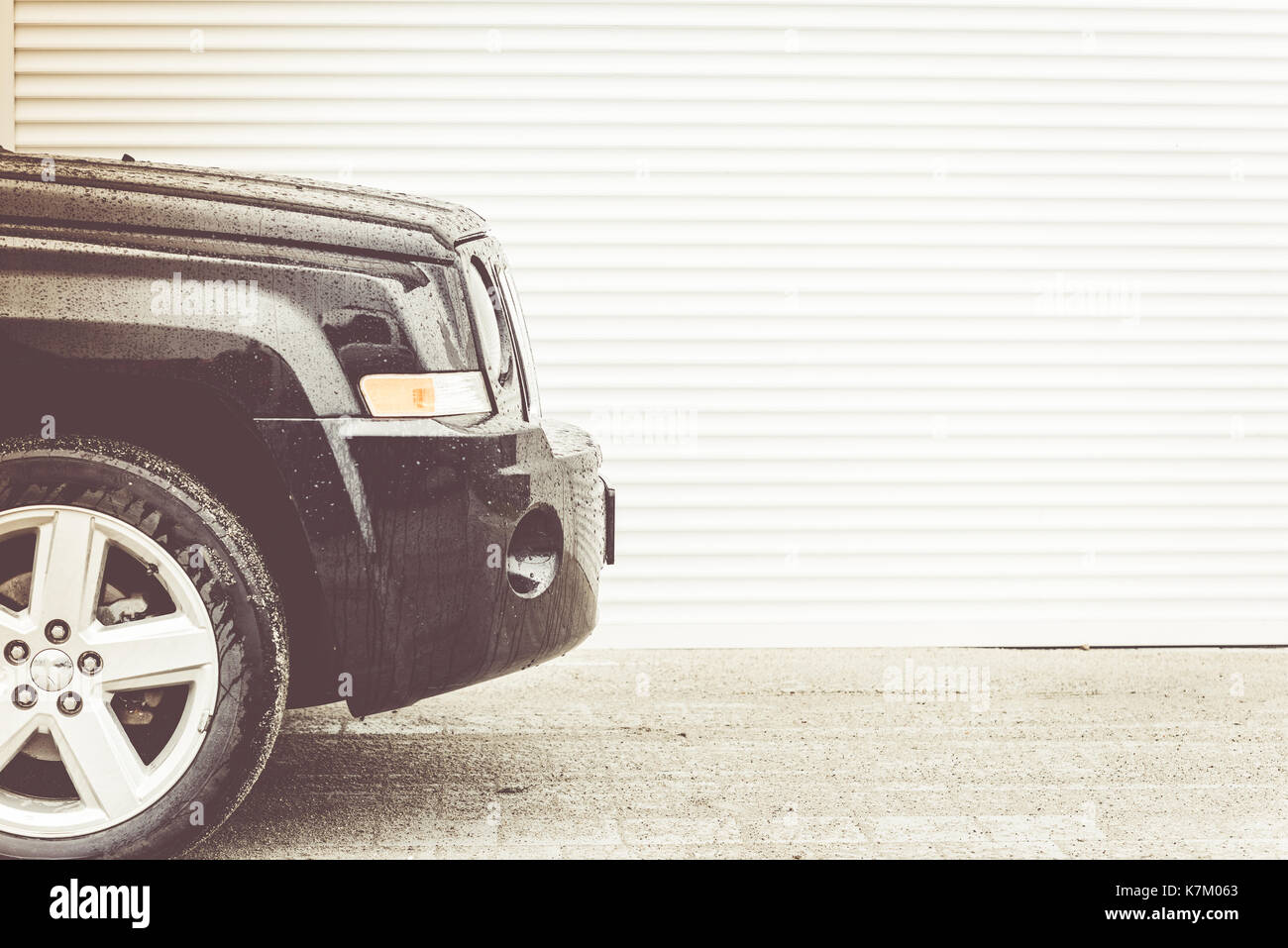 Off road 4x4 car fron agains garage door. Copy space bacground Stock ...