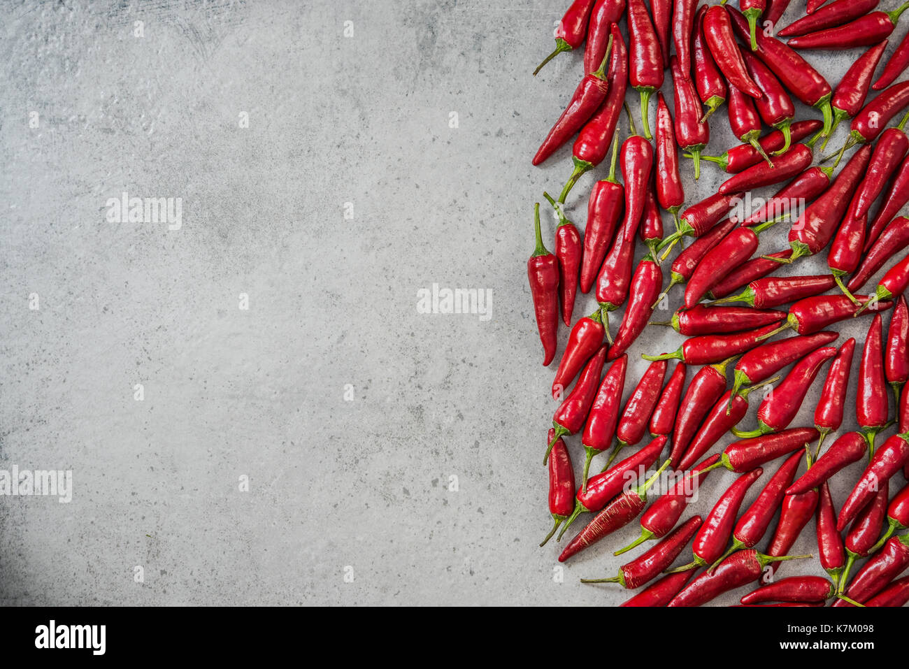 Hot red chili peppers border background Stock Photo - Alamy