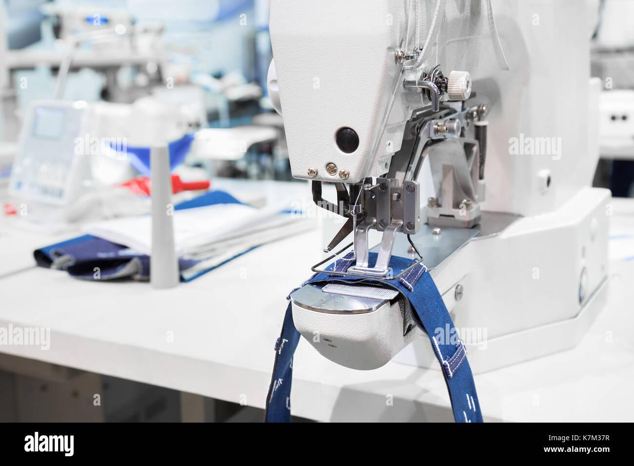 Sewing machine process a seam on jeans fabric Stock Photo - Alamy