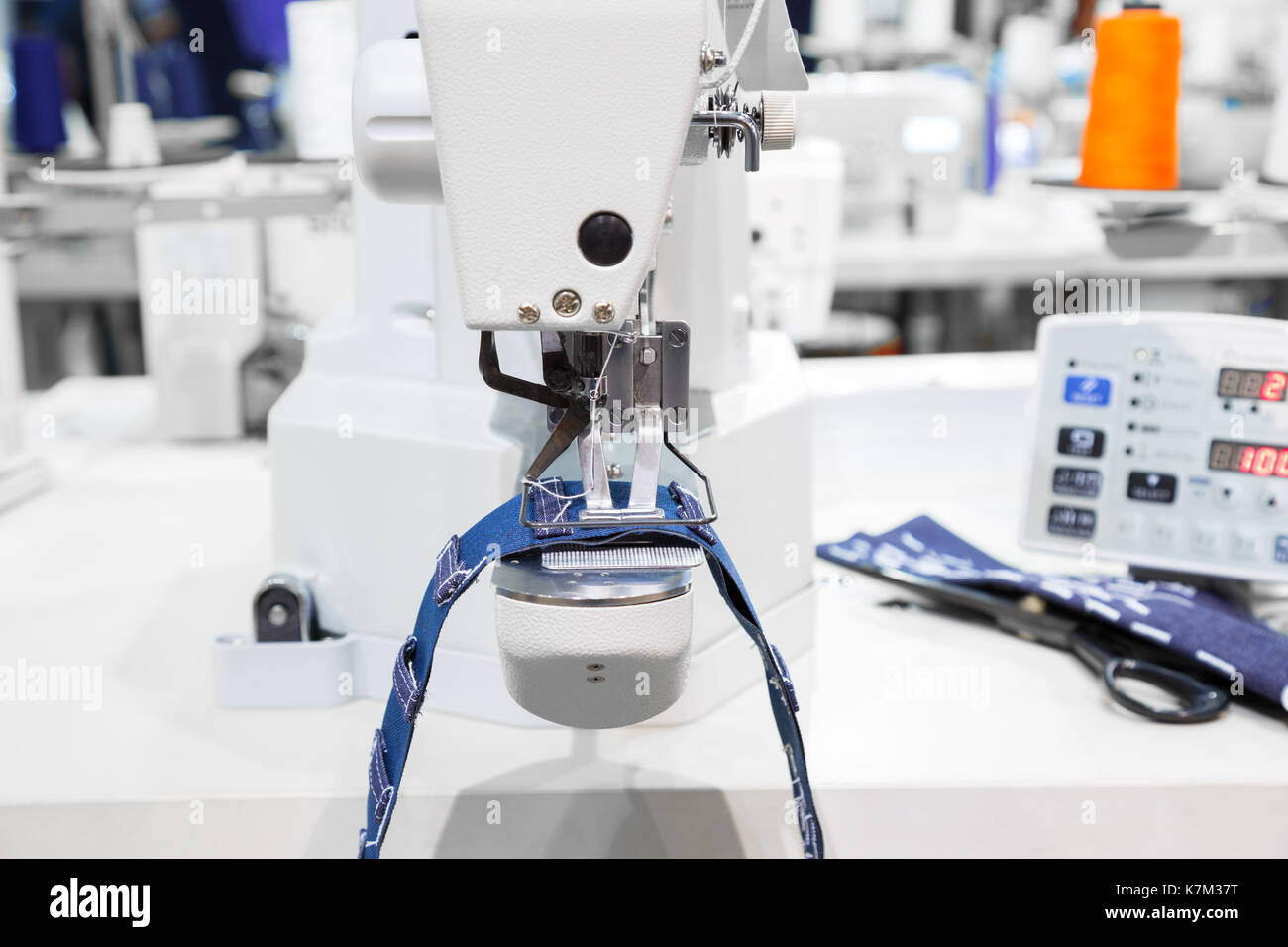 Sewing machine process a seam on jeans fabric Stock Photo - Alamy
