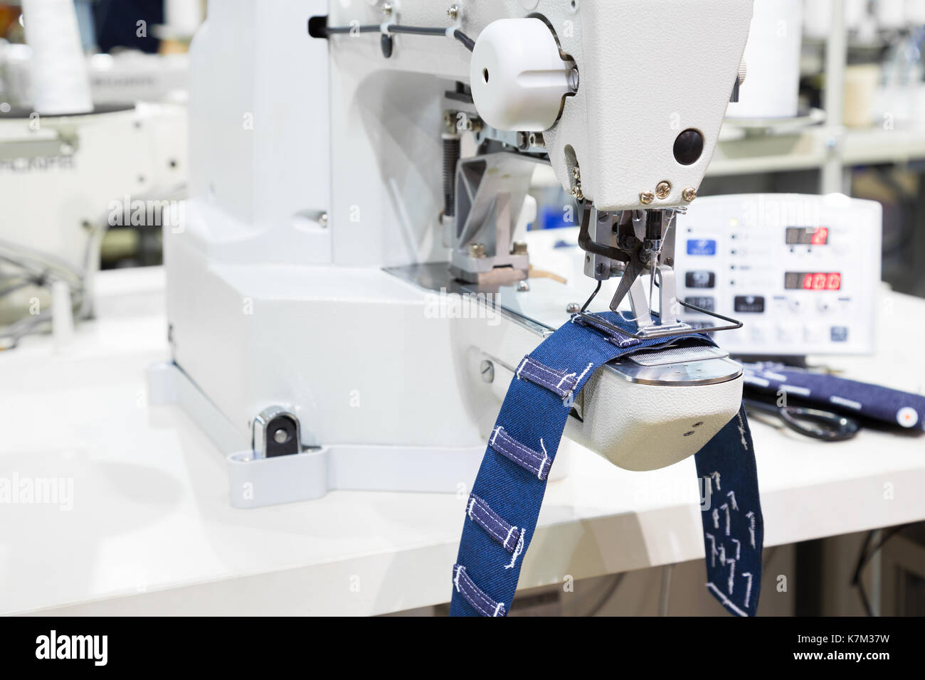Sewing machine process a seam on jeans fabric Stock Photo - Alamy