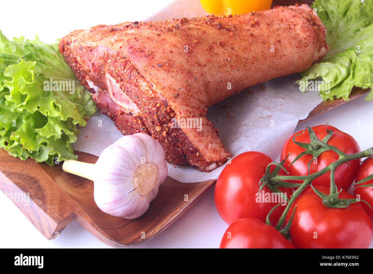 Raw pork knuckle and vegetables, garlic, tomatoes, bell pepper. spices ...