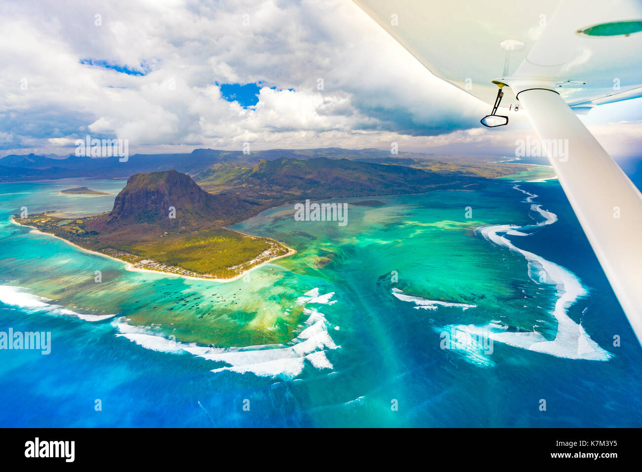 Aerial view of the underwater waterfall. Plane wing on the foreground ...