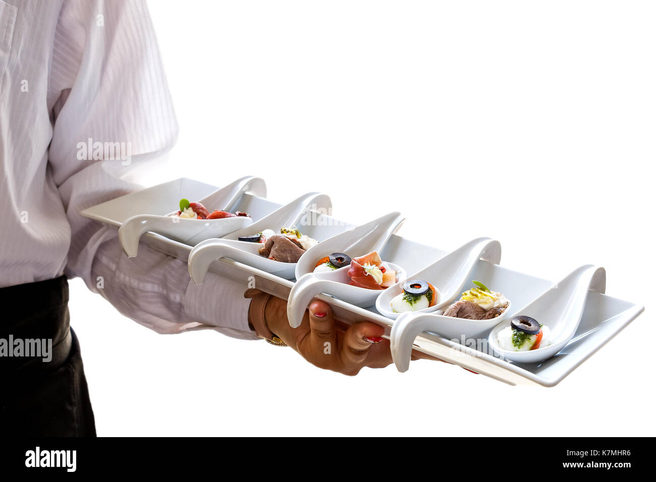 Waitress holding selection of canapes on ceramic spoons Stock Photo - Alamy