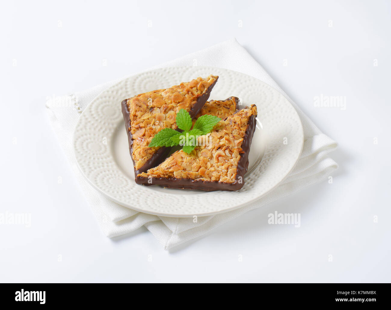 Triangle nut bars dipped in chocolate Stock Photo - Alamy