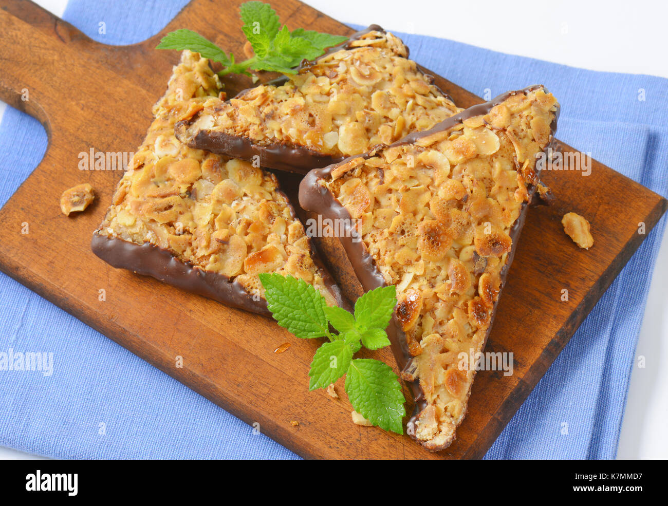 Triangle nut bars dipped in chocolate Stock Photo - Alamy