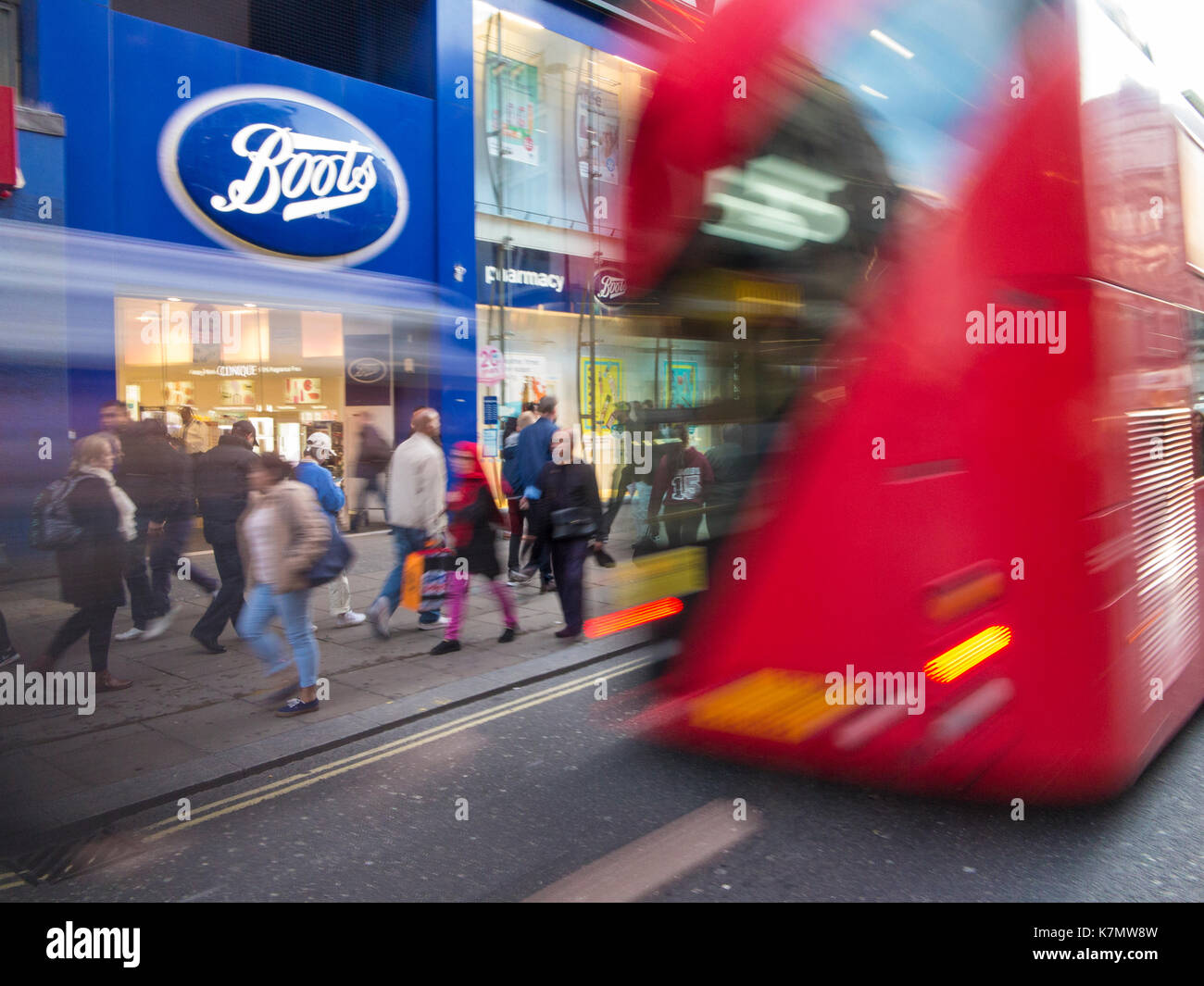 A blurred bus passes by a branch of a chain store in London Stock Photo ...