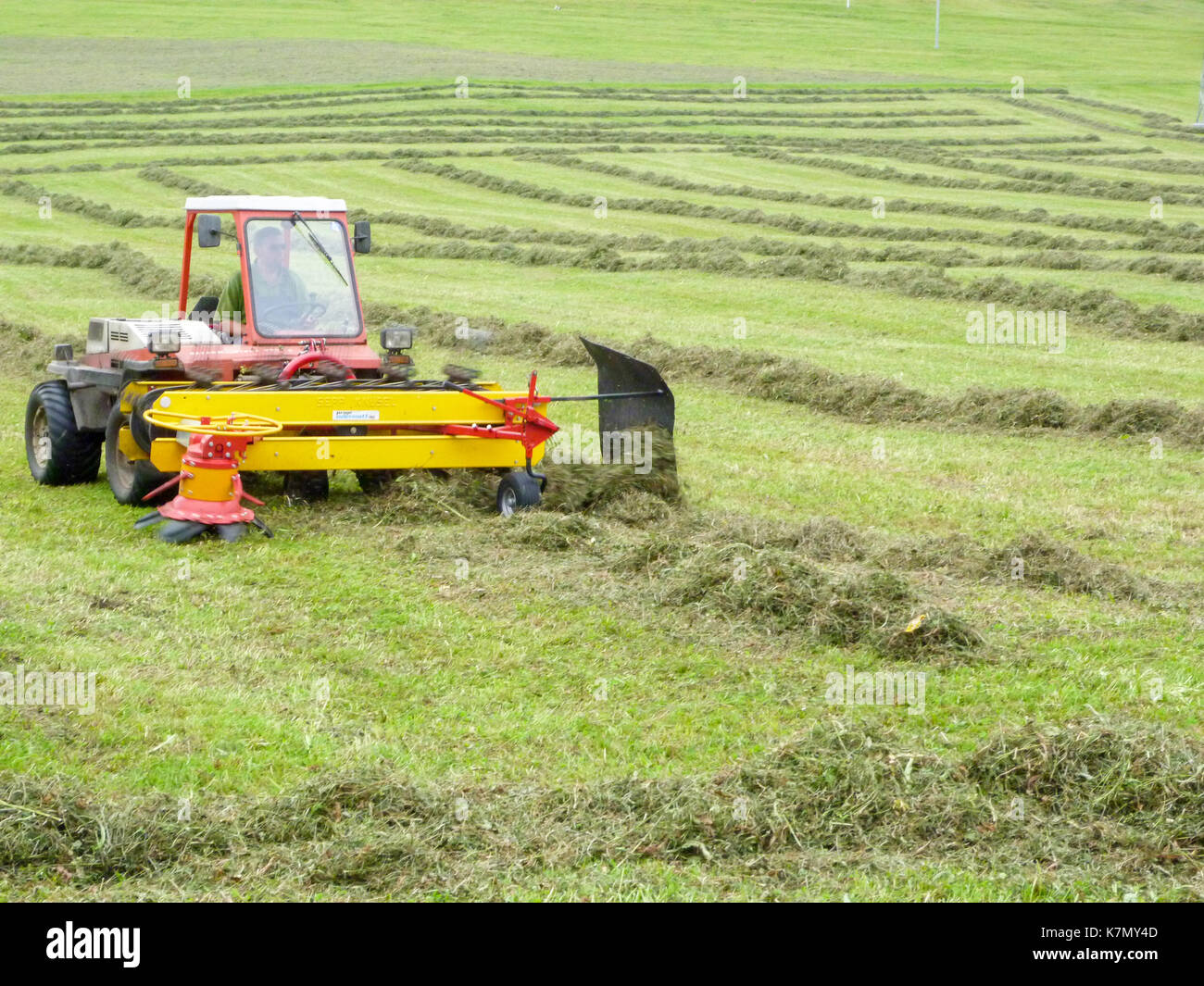 Engelberg, Switzerland - 3 August 2017: farmer on his tractor that ...
