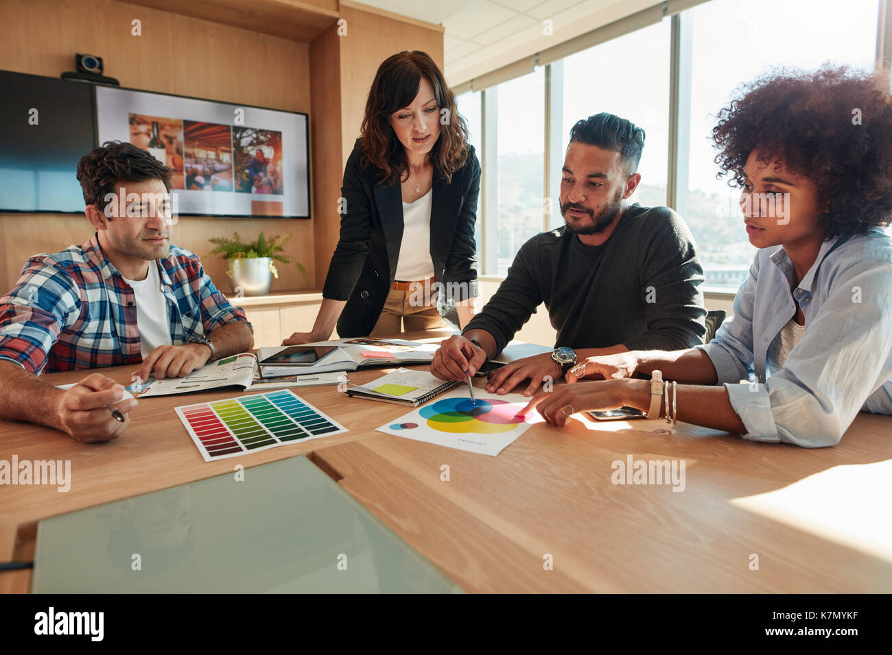 Group of creative designers team discussing project, choosing color ...