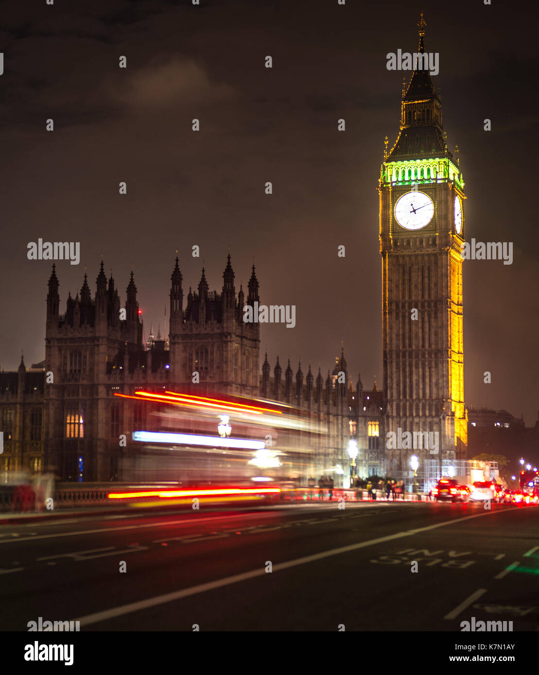 Palace of Westminster with Big Ben at night, red double-decker bus on the Westminster Bridge ...