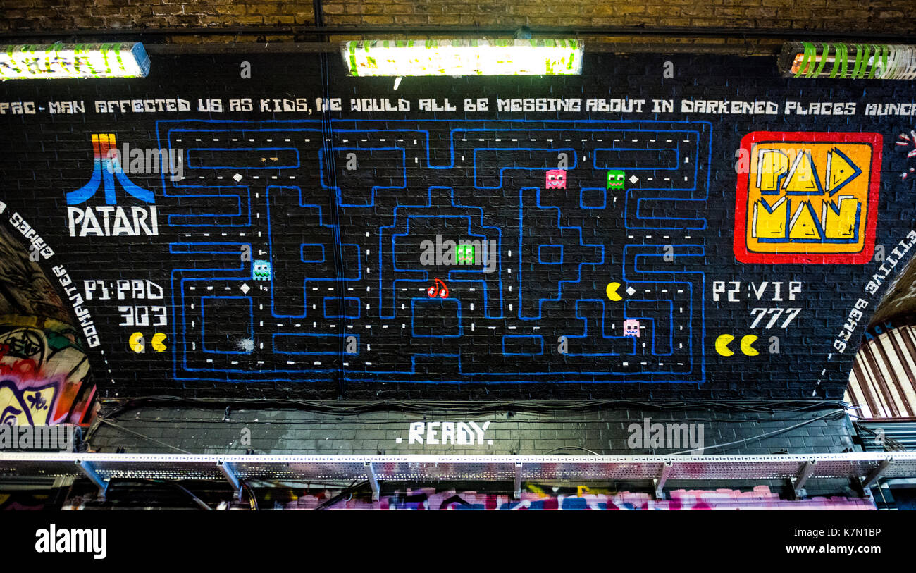 Graffiti of the computer game Pac-Man in a pedestrian tunnel, London ...