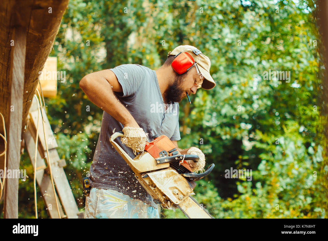 Portrait of lumberjack logger worker in protective workwear with ...