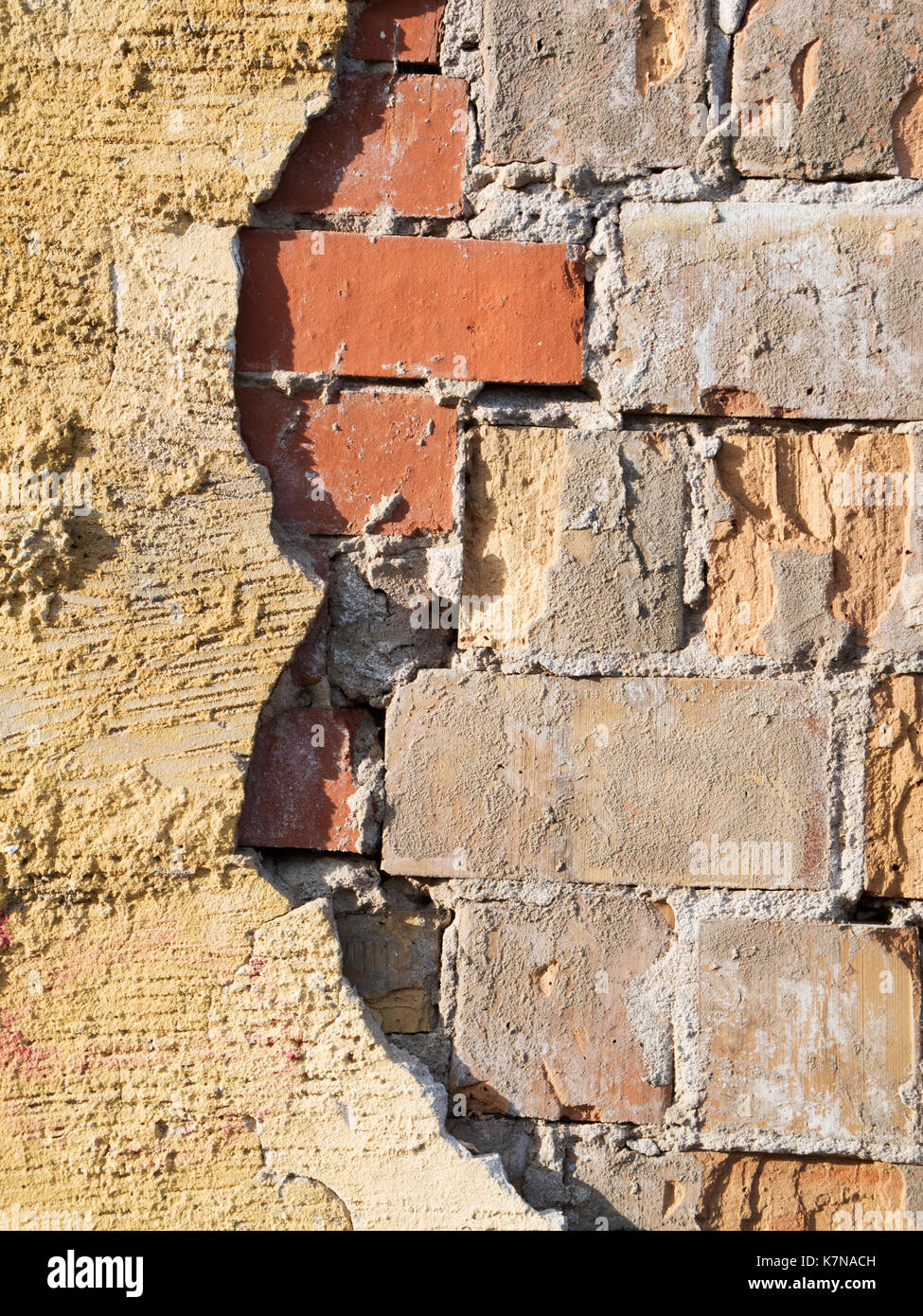 Format filling view old masonry with partially detached rough plaster ...