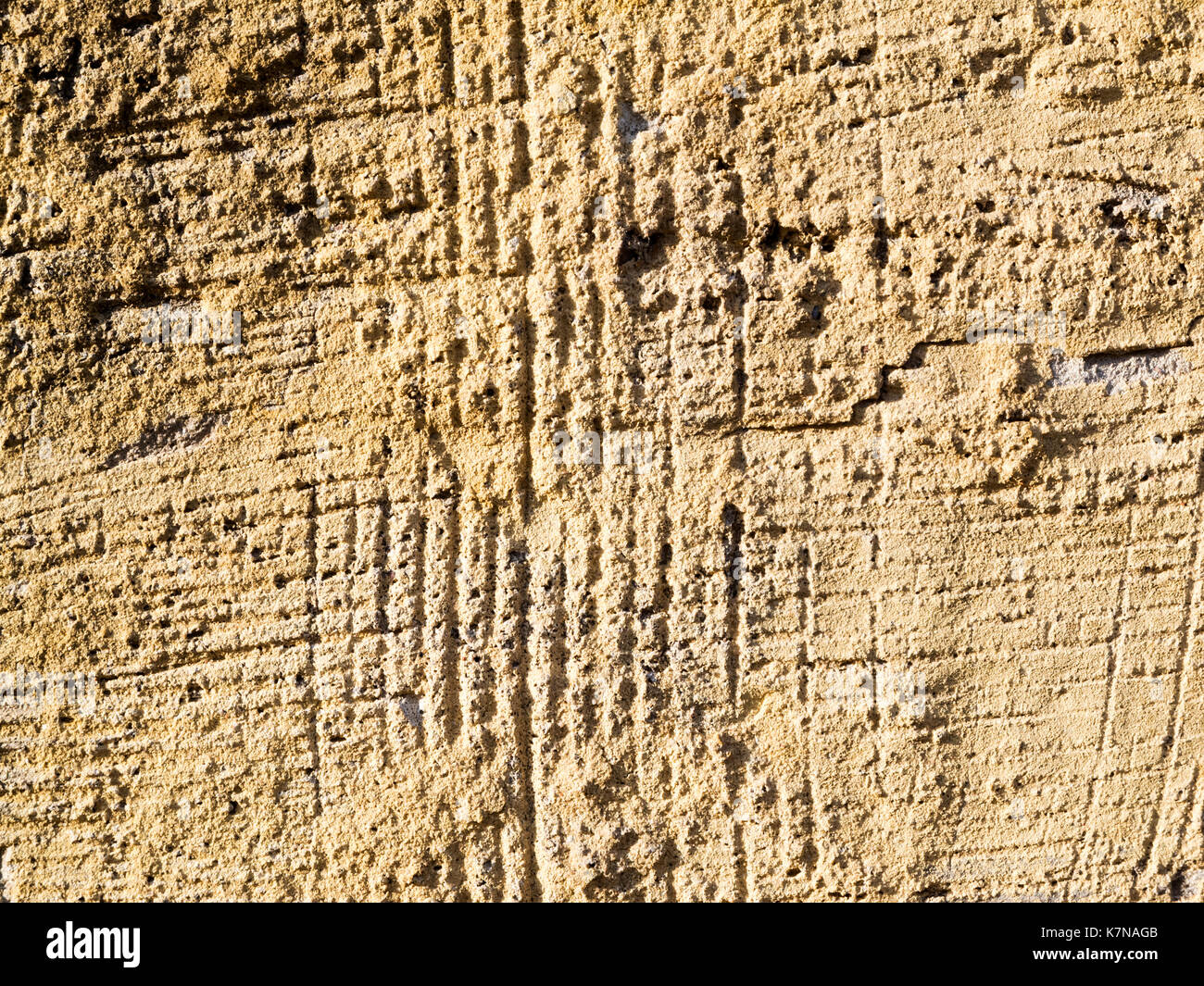 Format filling view old masonry with partially detached rough plaster ...