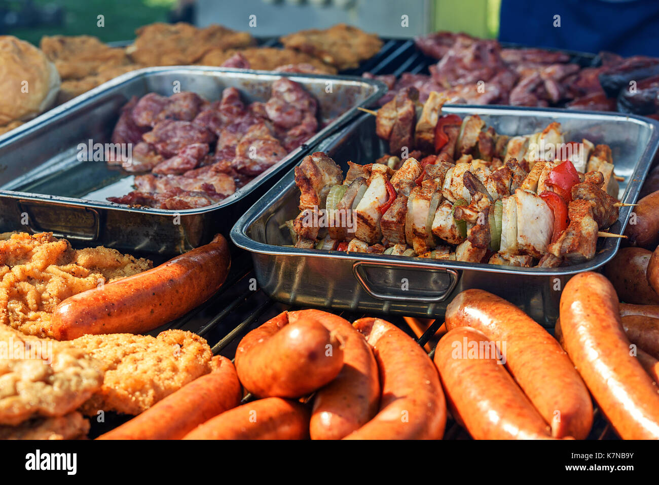 Different kinds of meat dishes on the barbeque during the party in the ...