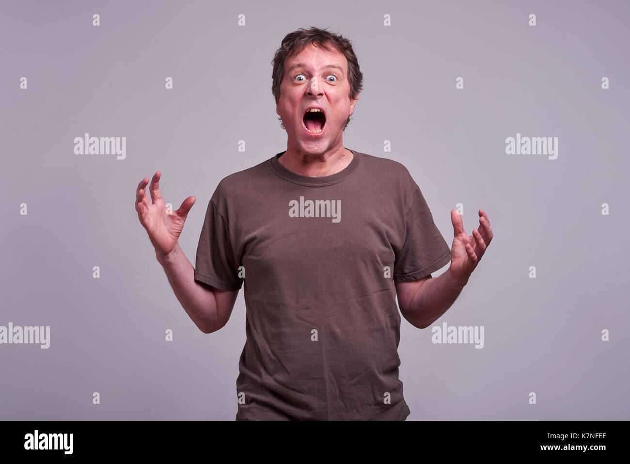 A middle aged man standing and screaming Stock Photo - Alamy